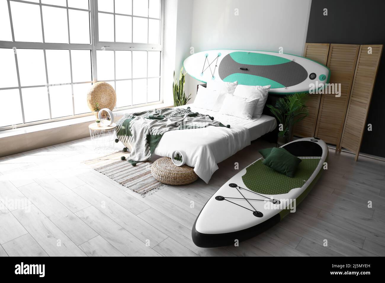Interior of modern bedroom with boards for sup surfing Stock Photo - Alamy