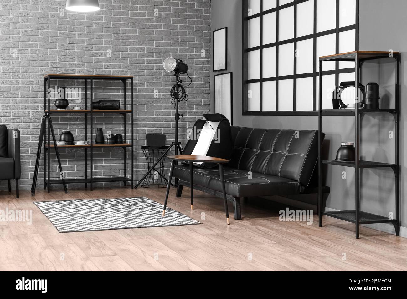 Interior of modern photo studio with shelving units, couch and ...