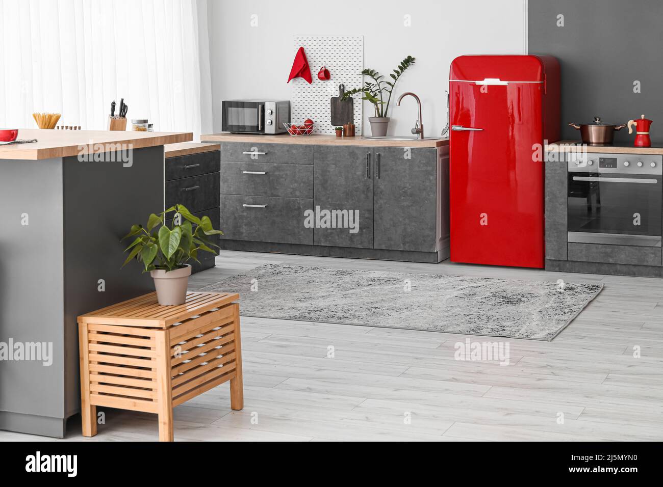 Interior of modern kitchen with red fridge, counters and pegboard Stock ...