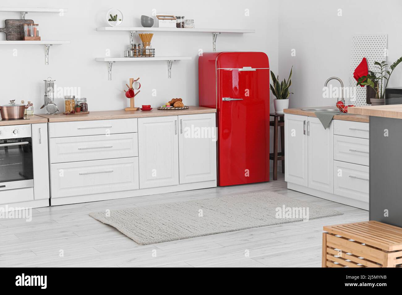 Interior of light kitchen with red fridge, counters and shelves Stock ...