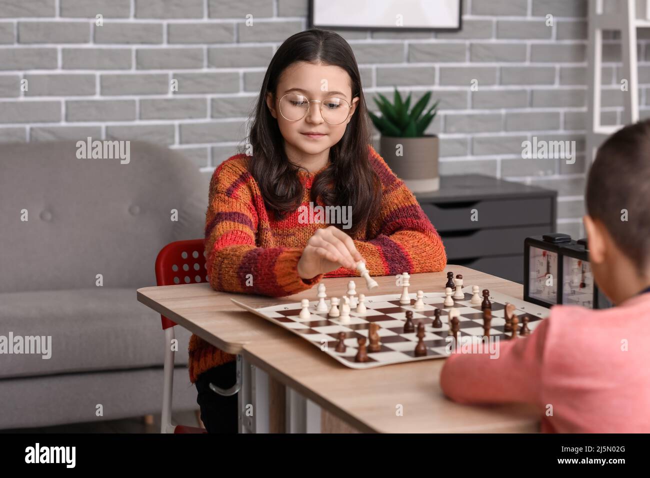 Little children playing chess during tournament in club Stock Photo - Alamy