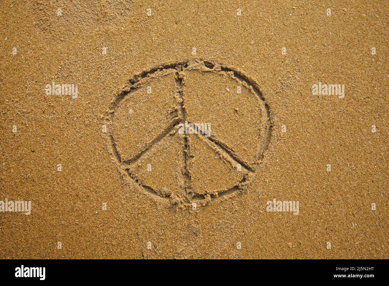 Peace sign is drawn on the soft beach sand Stock Photo - Alamy