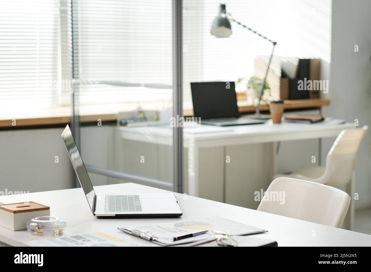 Modern portable computer, clipboard with documents on office table in ...