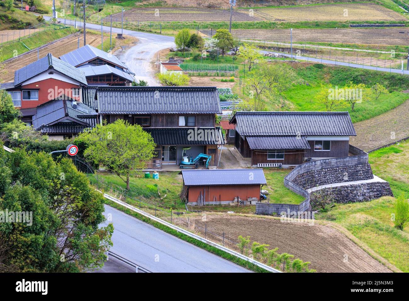 Overhead view of farmhouse and land next to road Stock Photo - Alamy