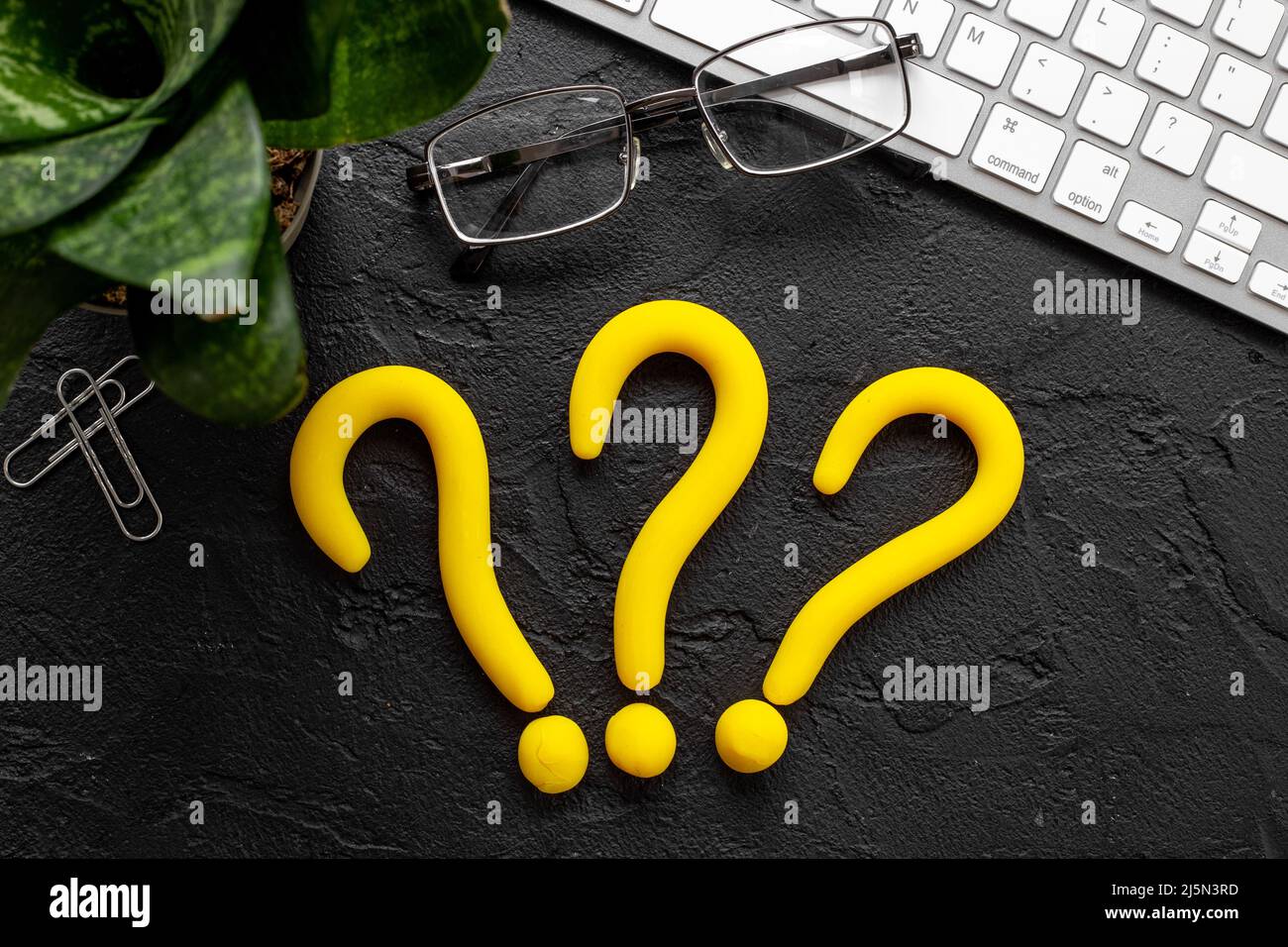 Question mark symbol on office desk. Solving problem or search solution ...