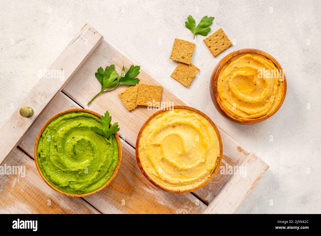 Flatlay of different types of colorful hummus in bowls. Vegan food ...