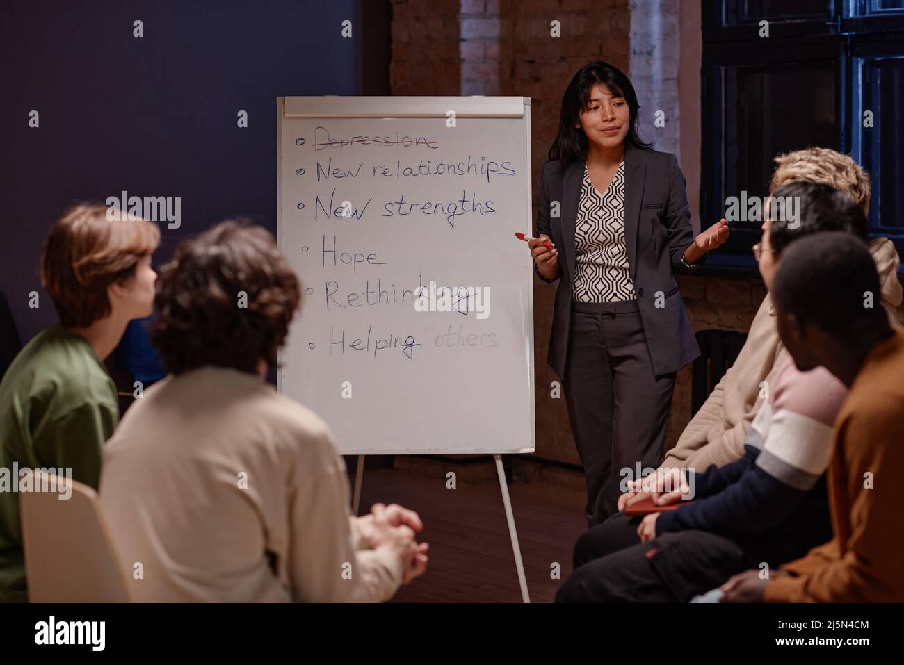 Horizontal shot of professional psychologist standing in front of ...
