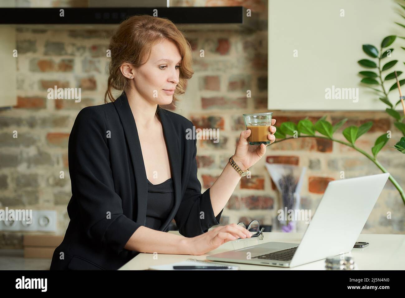 A boss listening to a discussion of a project with employees at a video ...