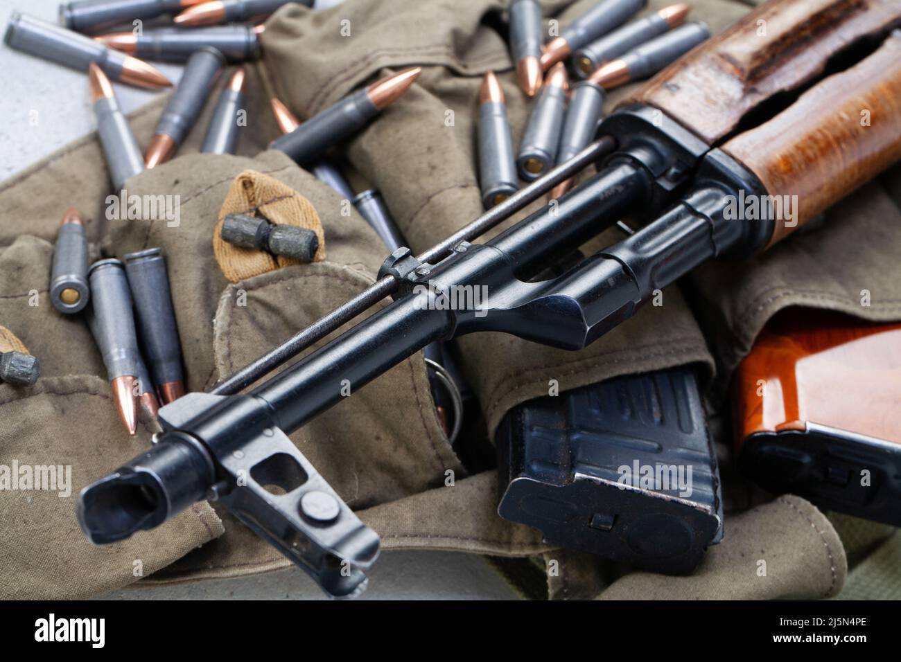 Kalashnikov ak gun and Chicom Chest Rig with 7,62 mm cartridges on grey ...