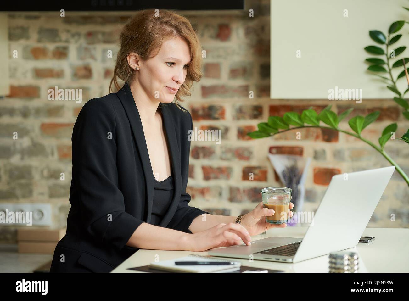 A boss listening to a discussion of a project with employees at a video ...