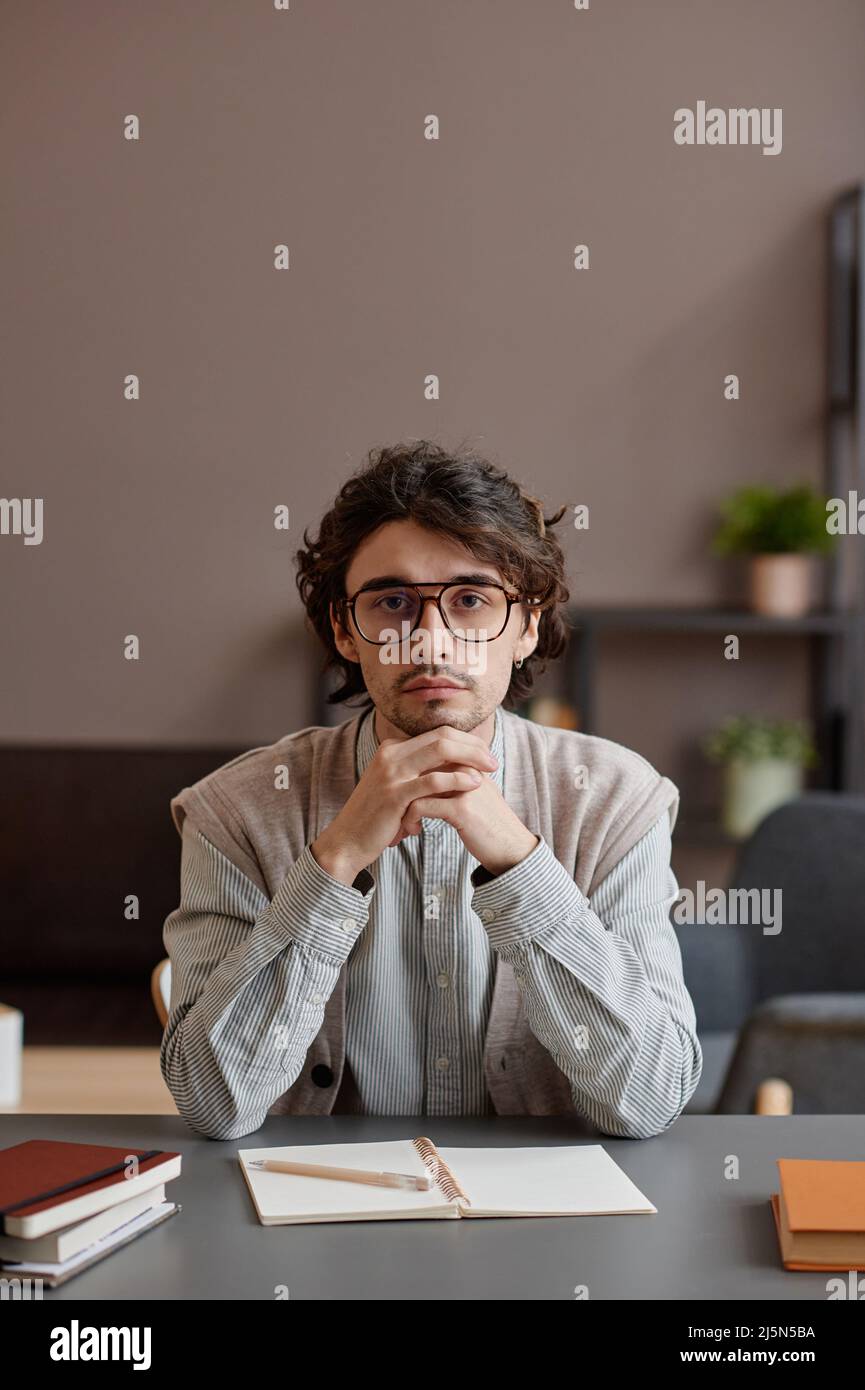 Vertical medium portrait of handsome young adult man working as ...