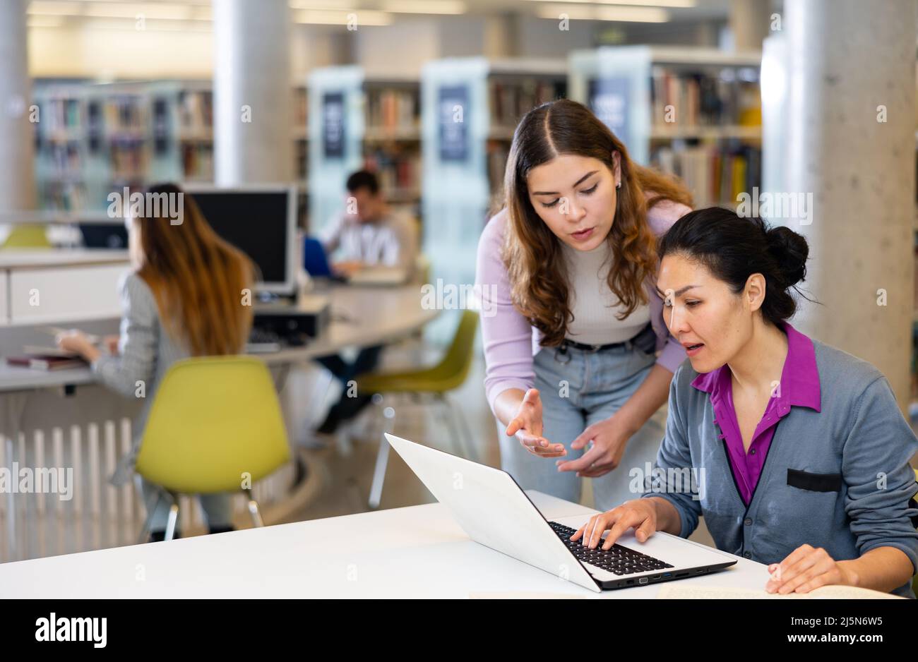 Reading book laptop librarian hi-res stock photography and images - Alamy