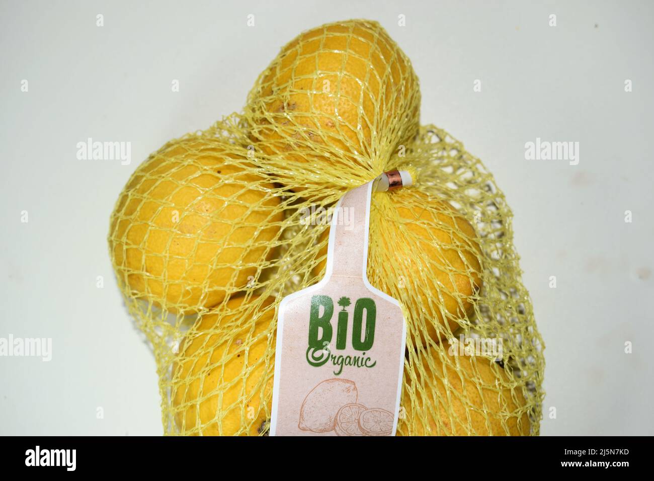 bio organic yellow lemons in a net fruit bag Stock Photo - Alamy