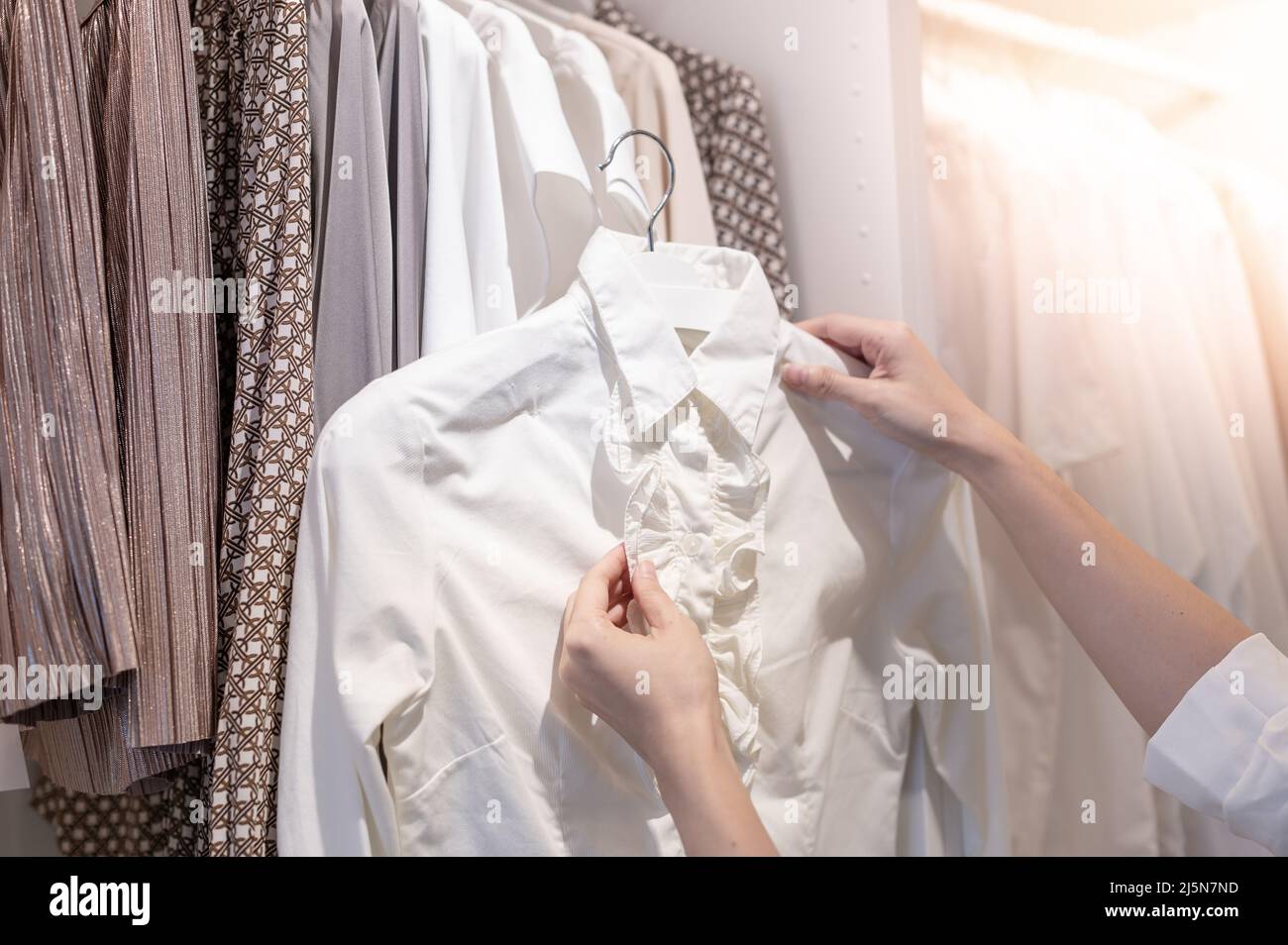 Female hand choosing clothes for checked pattern cotton polo shirt on ...