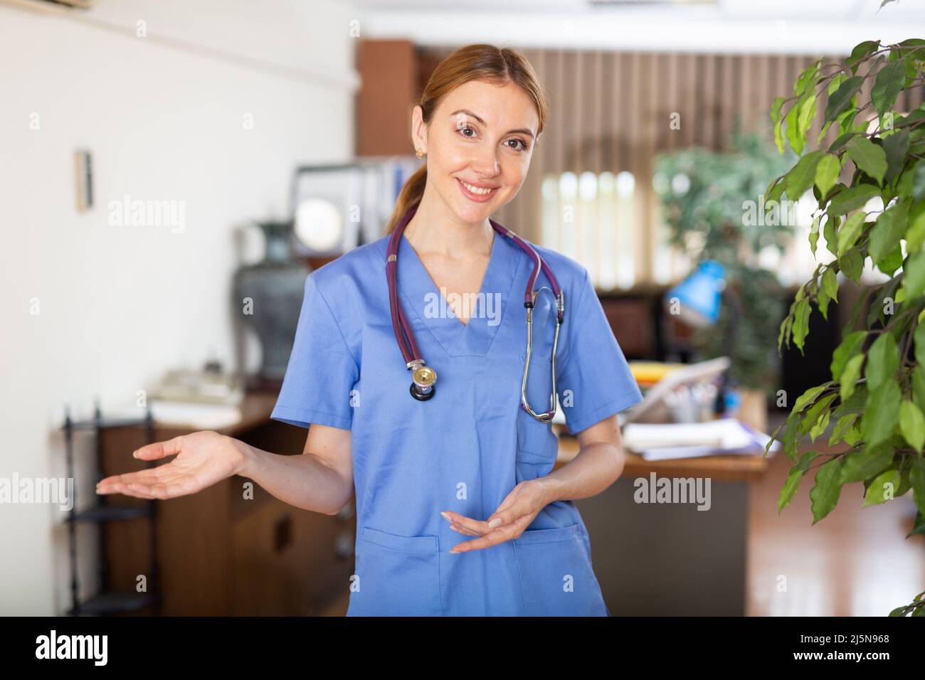 Nurse standing in hall of clinic Stock Photo - Alamy