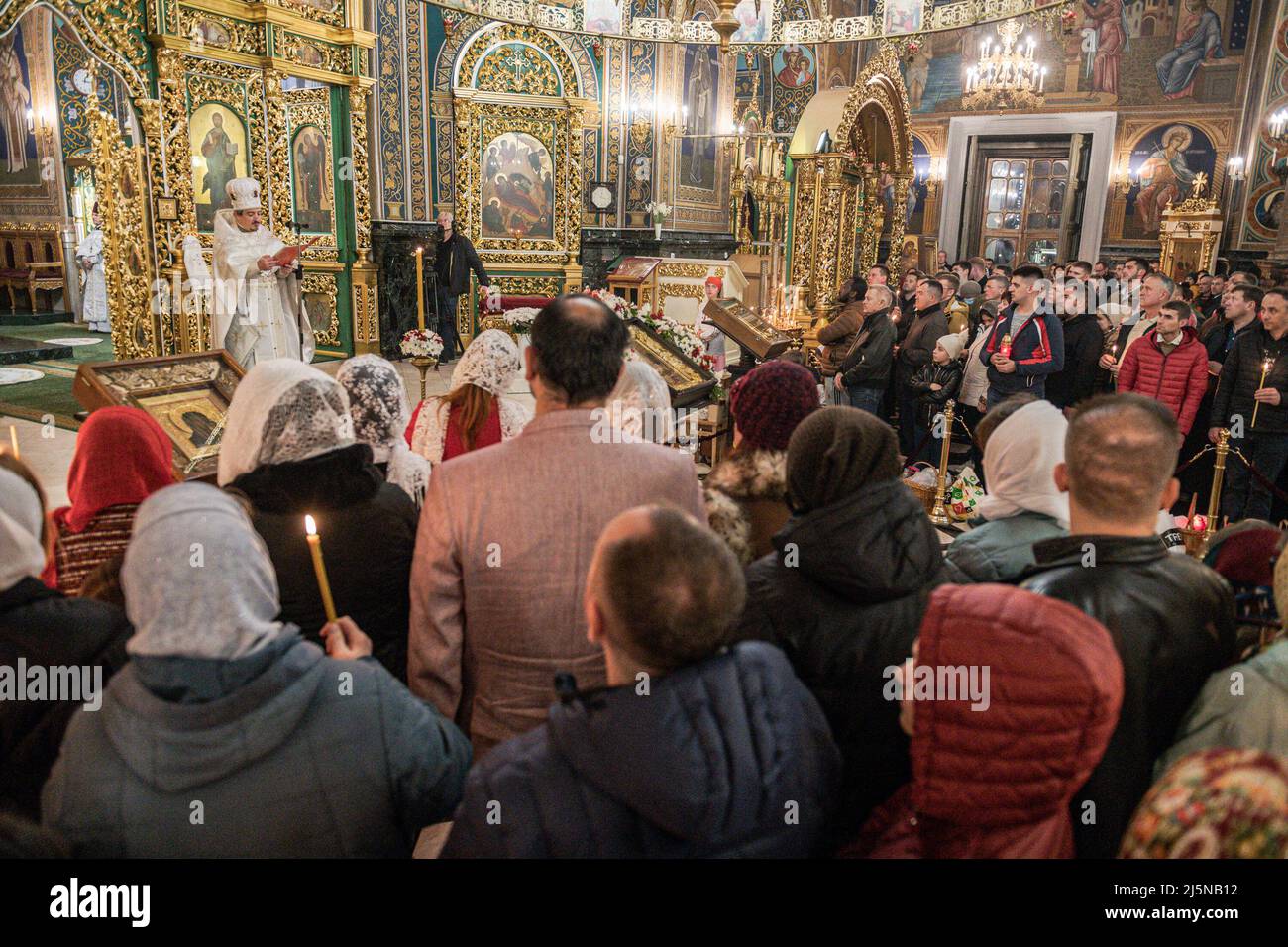 A group of believers from the Orthodox Church of Moldova listen to the ...