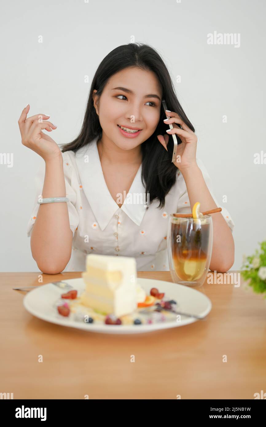 Portrait, A beautiful millennial woman sitting in the cafe, talking on ...