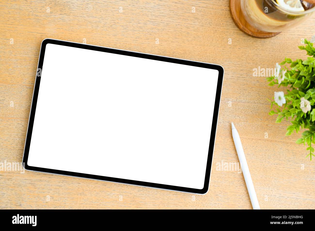 Top shot, A digital tablet touchpad white screen mockup with stylus pen ...