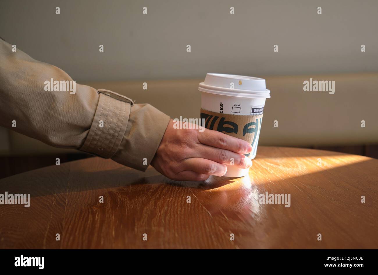 Starbucks coffee cup on table Stock Photo - Alamy