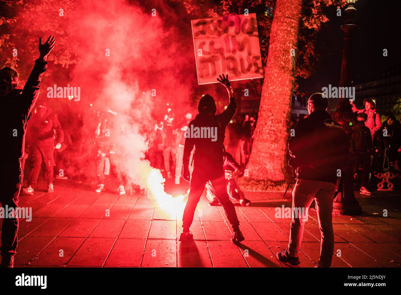 Young demonstrators hold smoke flares at Republic Square after the ...