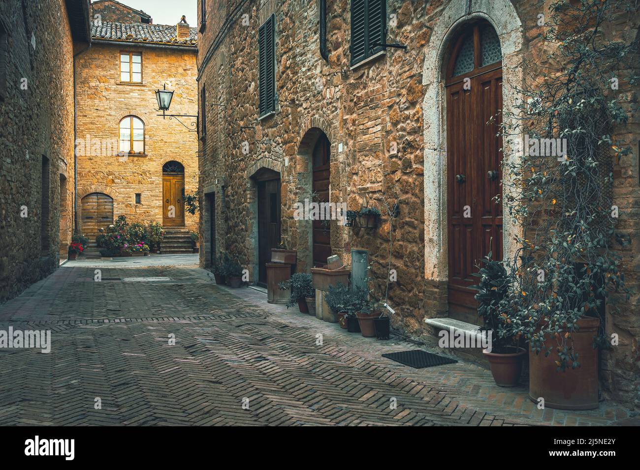 Rustic tuscan stone houses and cozy entrances decorated with colorful ...