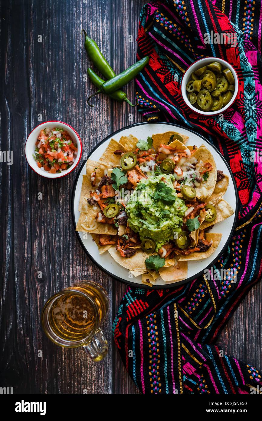 Mexican nachos chips with american cheese and avocado, traditional food ...