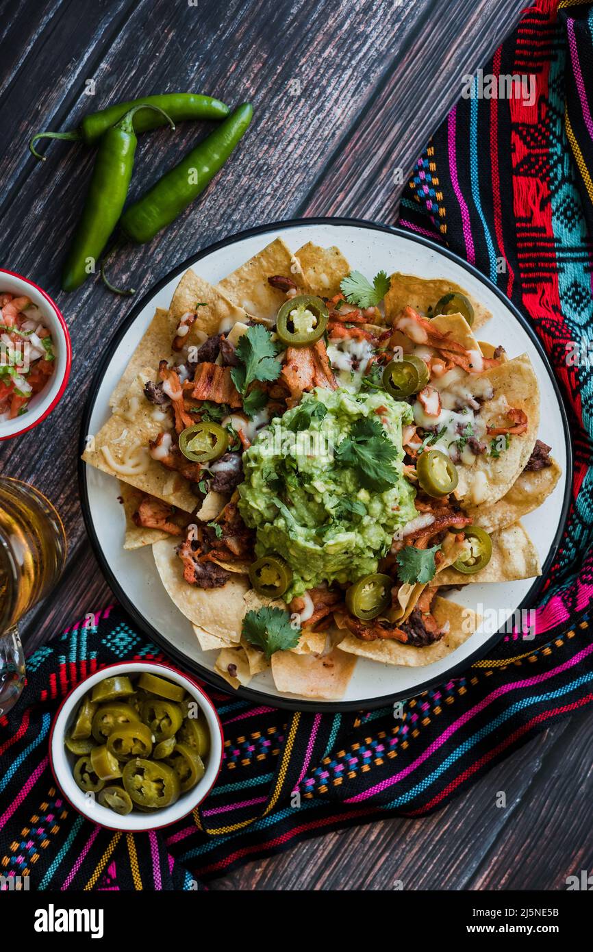 Mexican nachos chips with american cheese and avocado, traditional food ...