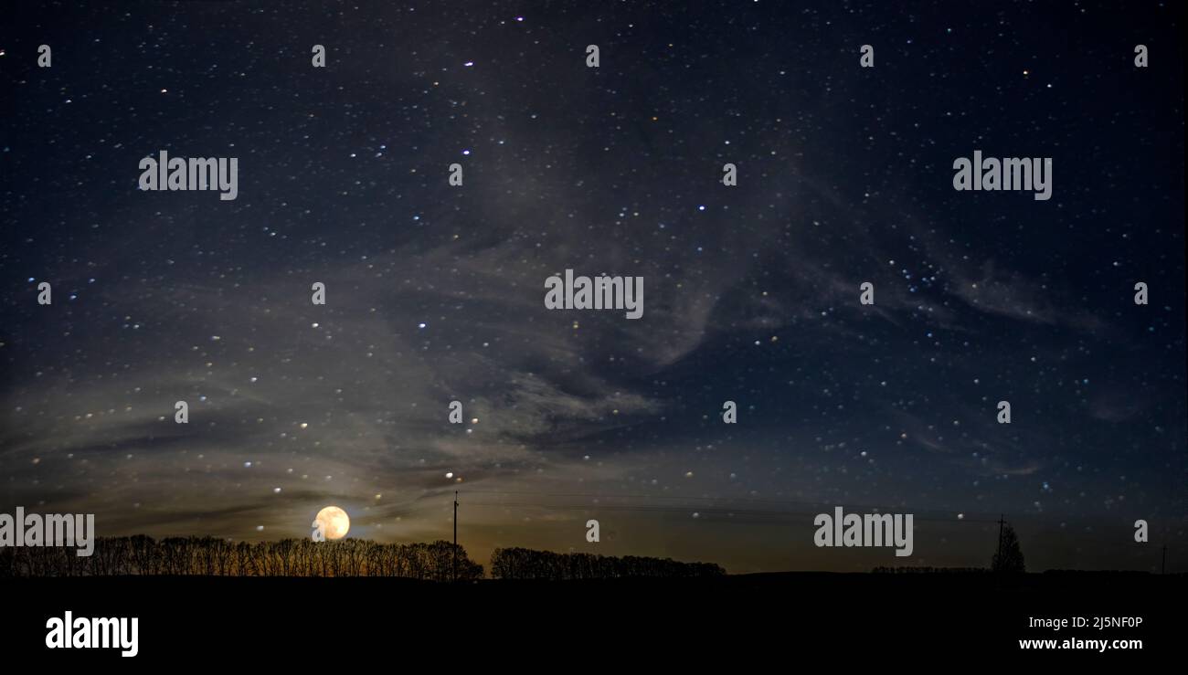 Panorama of night sky with clouds and stars. Moonlight Stock Photo - Alamy