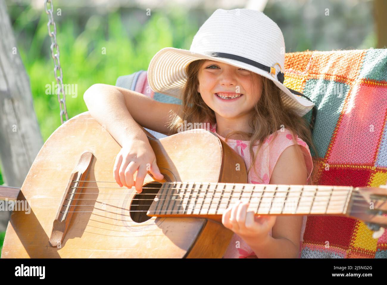 Musician child playing guitar. Kid girl singing and playing guitar ...