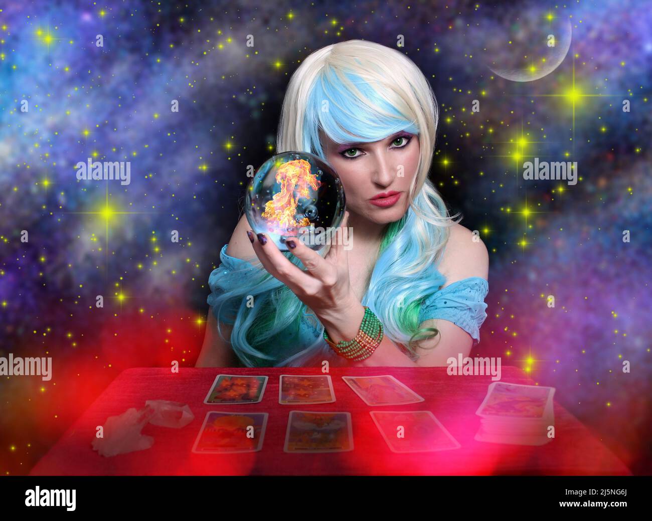 Psychic with blond hair Crystal Ball and tarot cards on galaxy ...