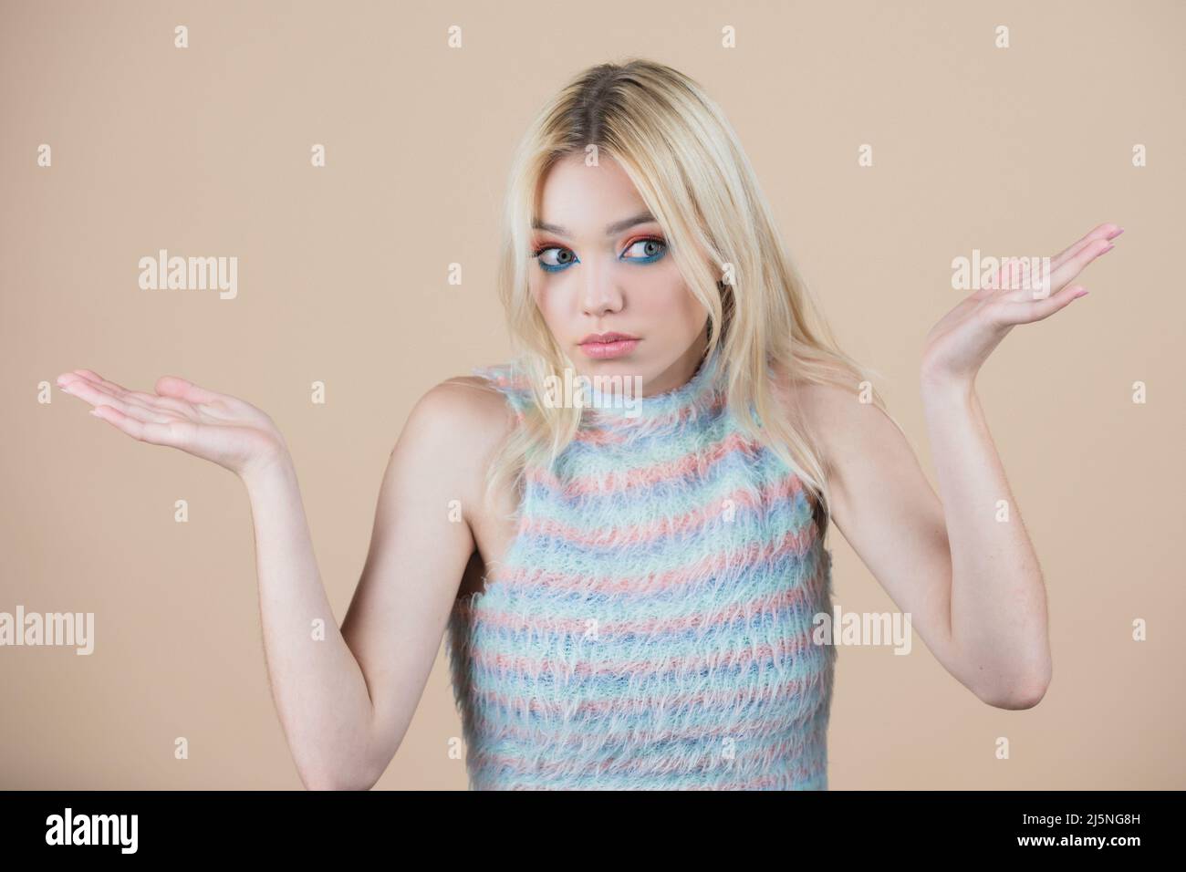 Confused beautiful blonde woman with questioning gesture. Girl ...
