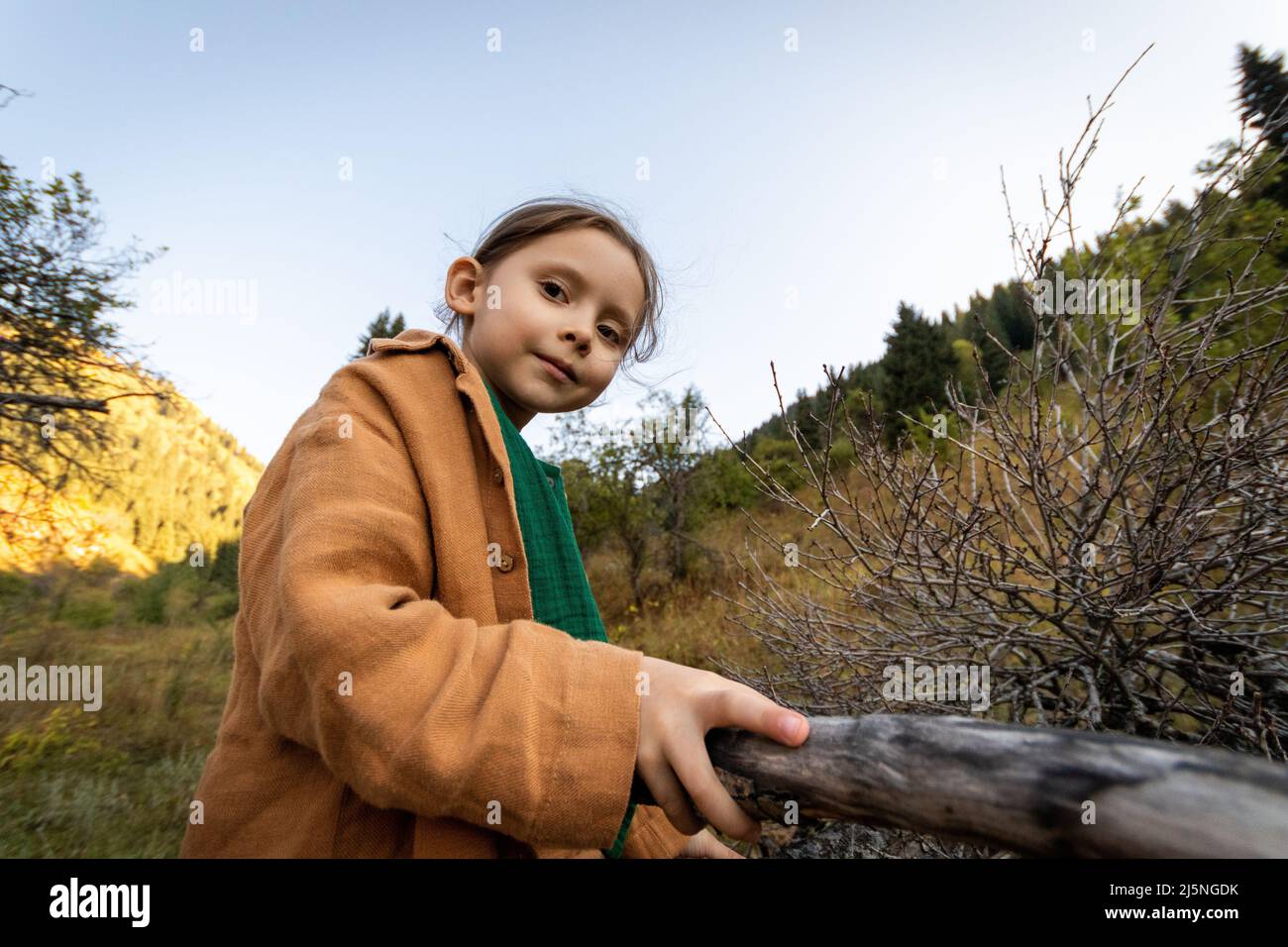 Portrait of a cute kid girl 5 years old walking in a hike in the ...