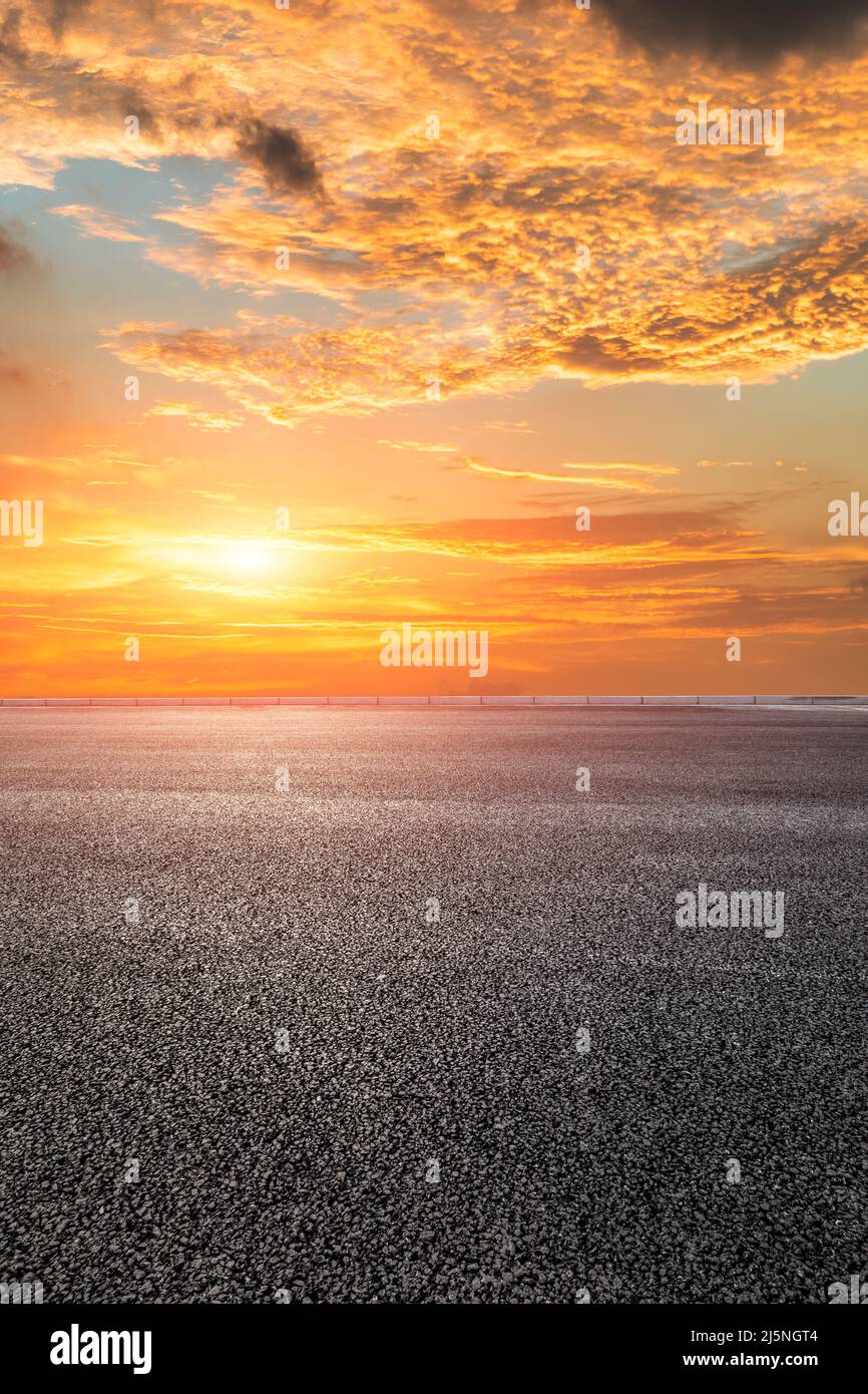Asphalt road platform and sky sunset clouds background Stock Photo - Alamy