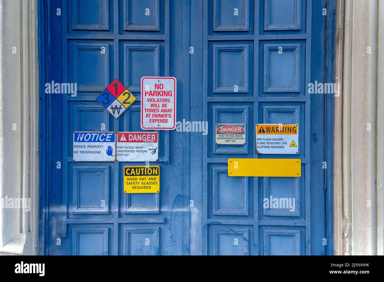Blue front door with warning signs displays at the front at San ...