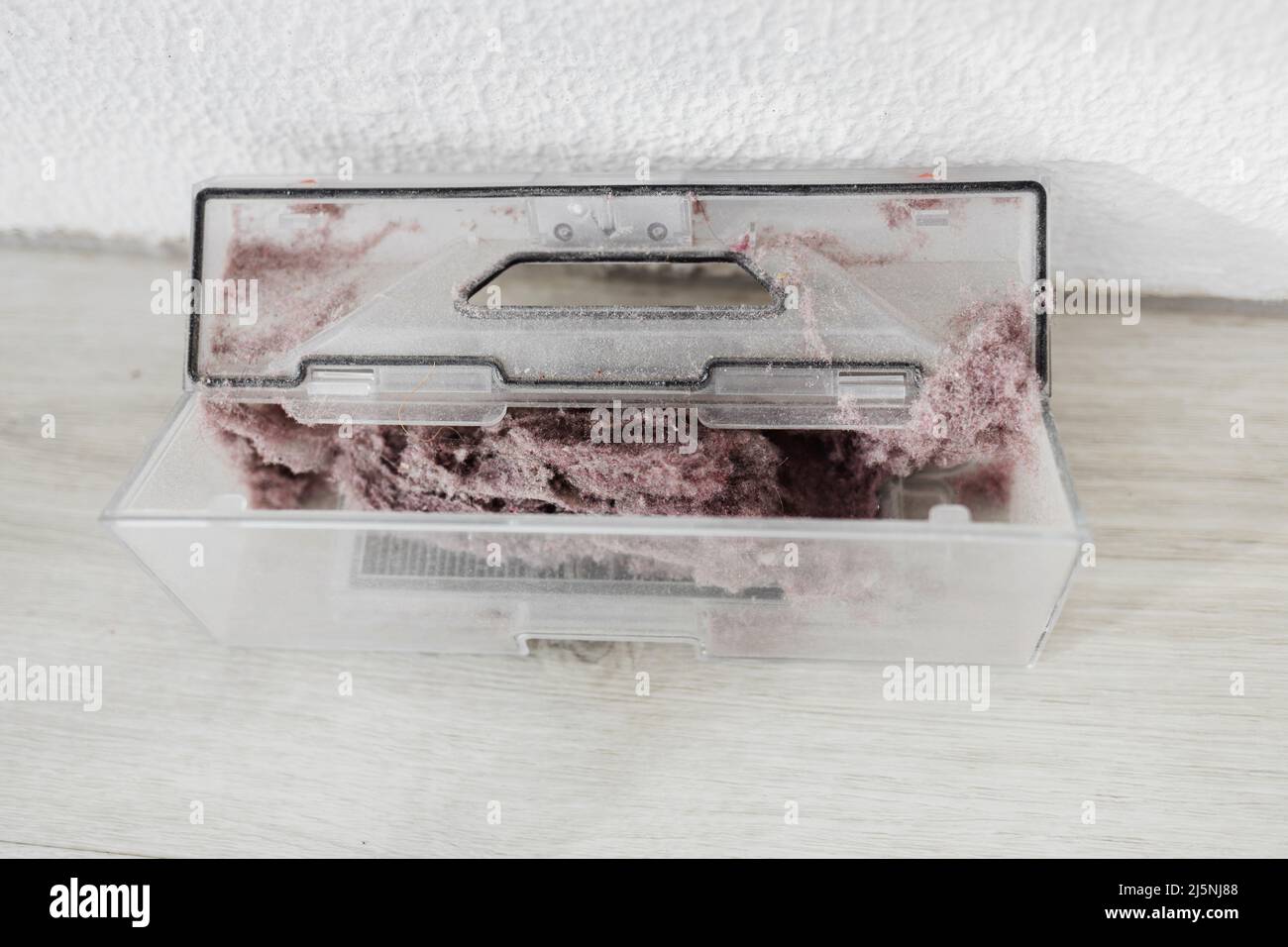 dust collector with garbage. robot vacuum cleaner Stock Photo - Alamy