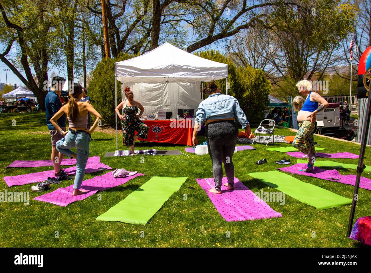 People take a yoga class at a Earth Day event. Earth day celebrations ...