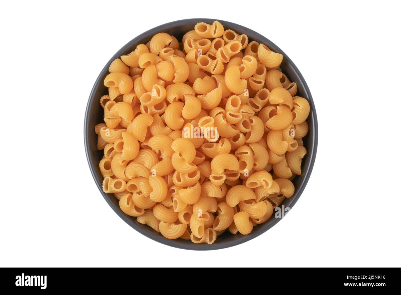 Dry uncooked pasta in a black ceramic cup isolated on a white ...