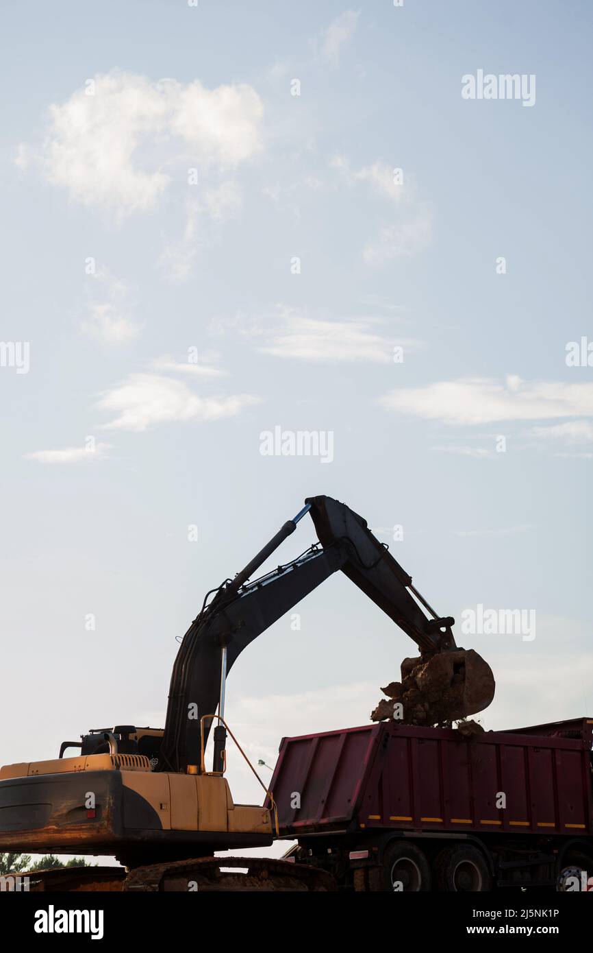 modern excavator performs excavation work on the construction site ...