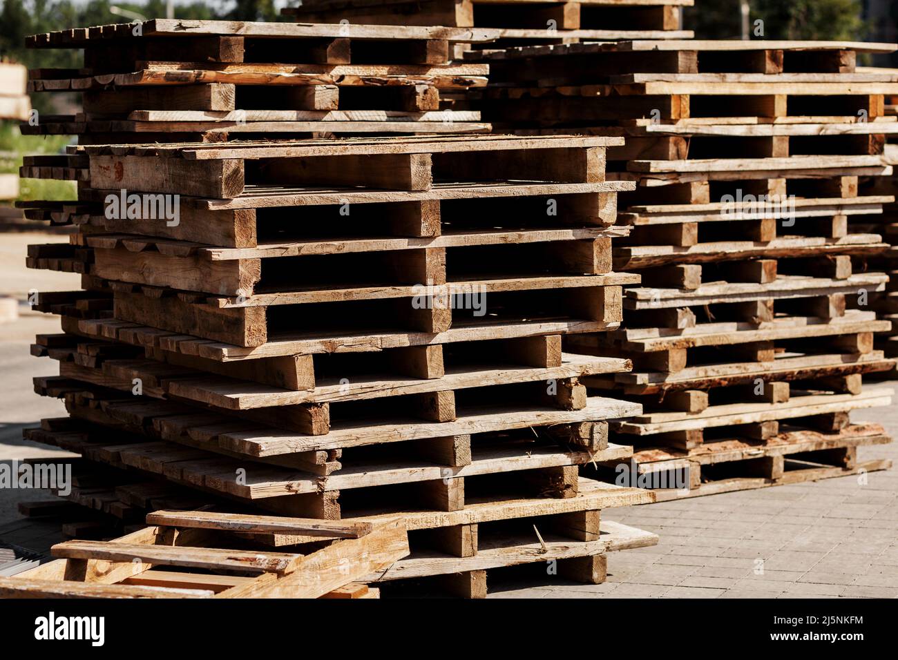 stack of pallets sit outside a building. storage area Stock Photo - Alamy