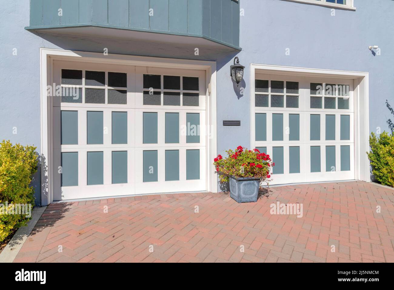 Double garage doors with glass and light blue panels with white grid ...