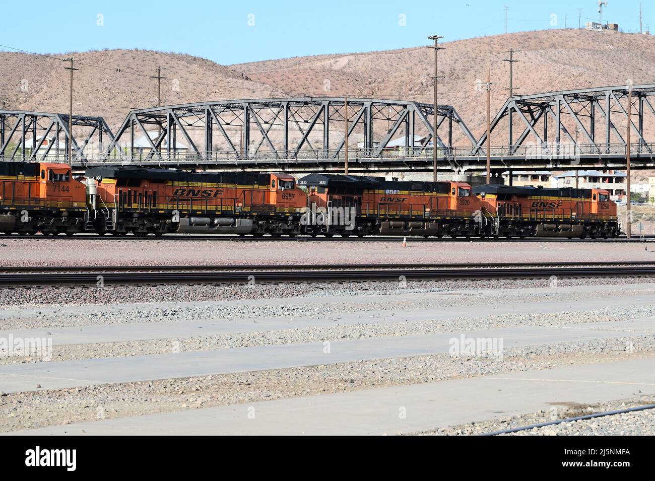 BNSF 7780 BNSF Railway GE ES44DC locomotive passing through Barstow station with a freight train ...