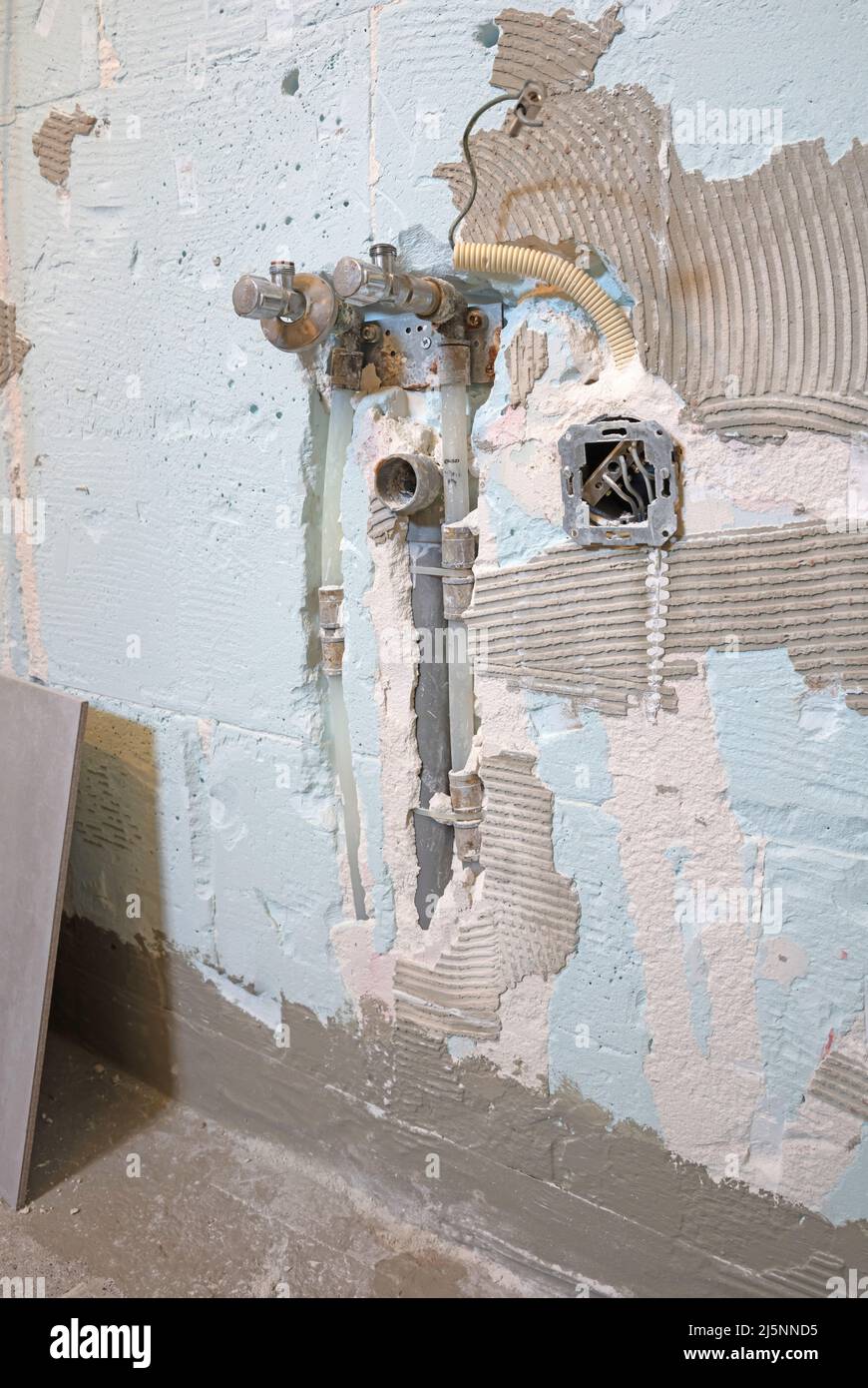 Drain pipe and water pipes in a plaster wall, under construction Stock ...