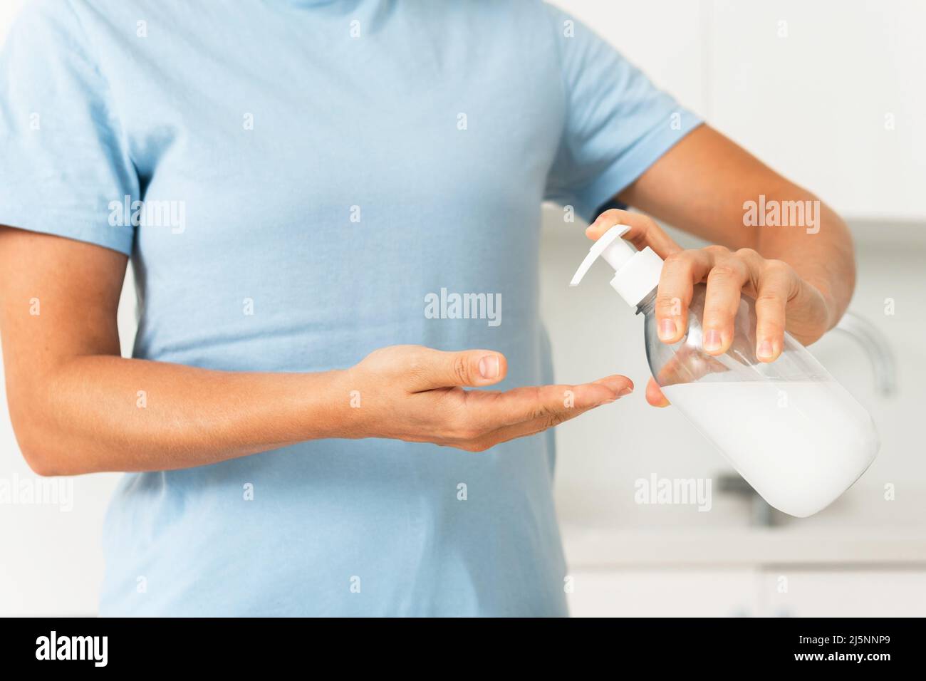 Woman using hand sanitizer or liquid soap for hands disinfection Stock ...