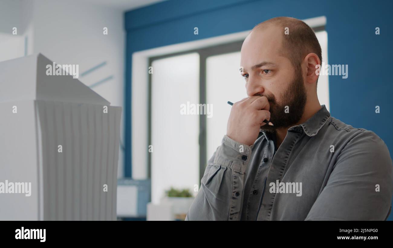 Close up of architect thinking about building strategy for construction ...