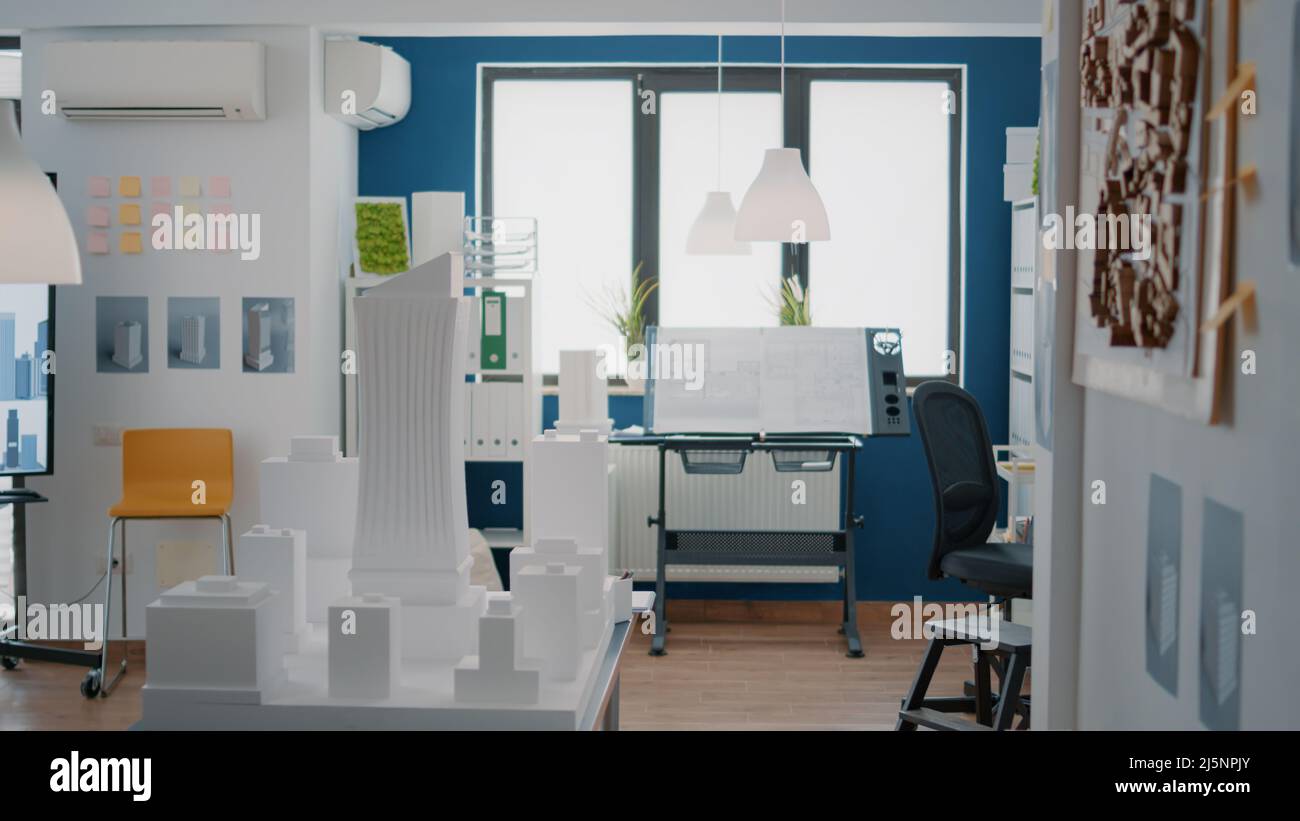 Nobody in office with blueprints plans to design building model for ...