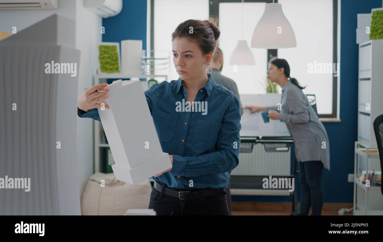 Portrait Of Woman Architect Analyzing Building Model To Create Urban Project Structure