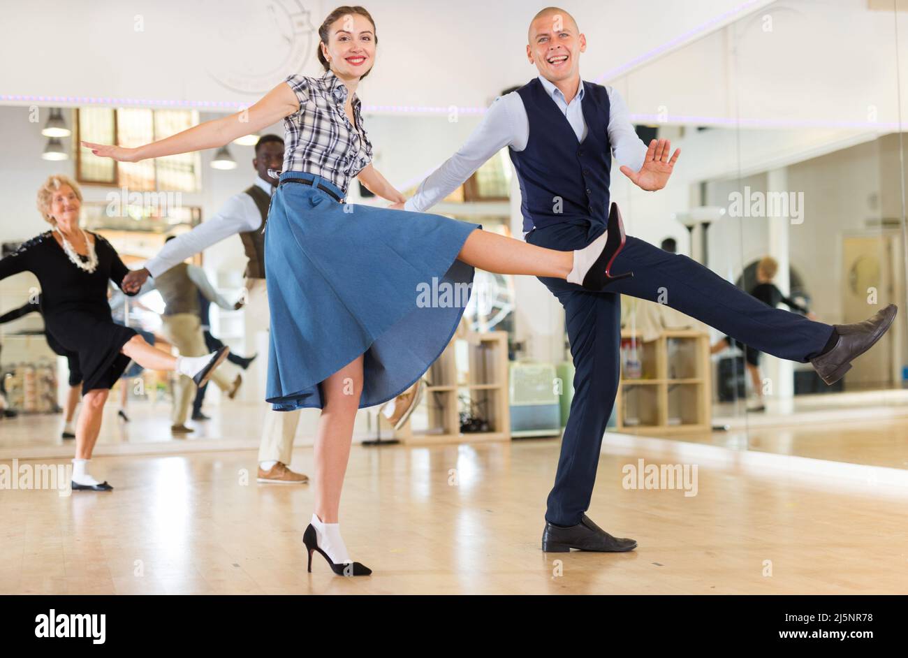 Man and woman performing jazz dance in dancing room Stock Photo - Alamy