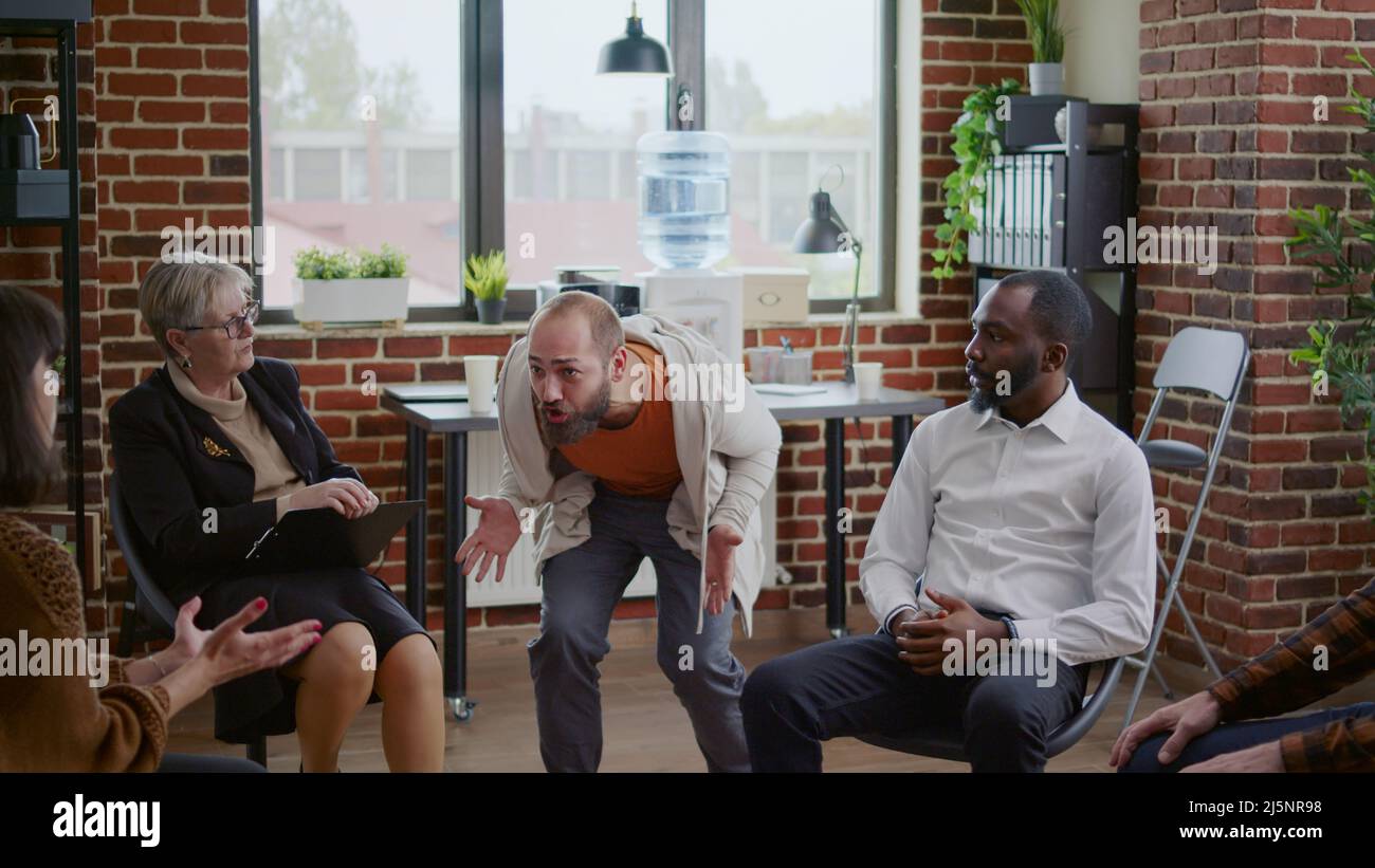 Alcohol addict having anger crisis at aa therapy meeting in front of ...