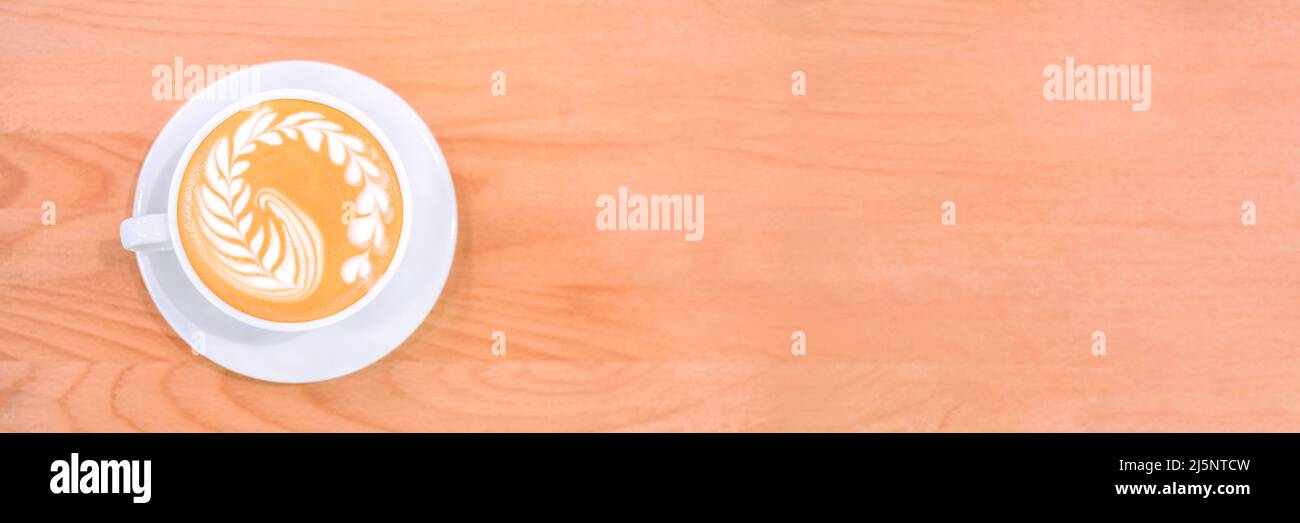 Banner with cappuccino with frothy foam, coffee cup top view is on the ...