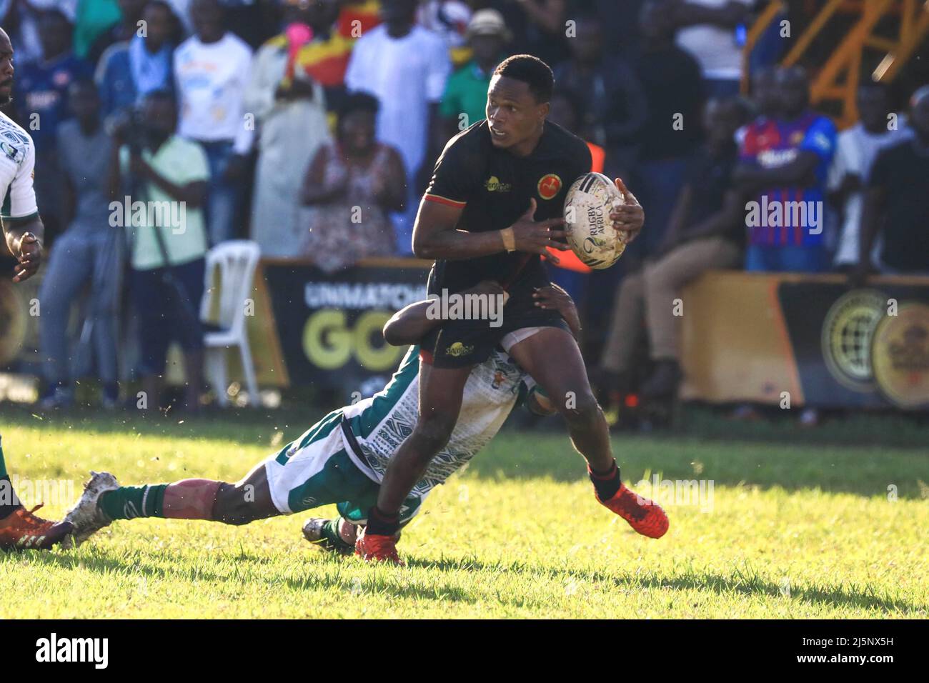 Kampala, Uganda. 24th Apr, 2022. Adrian Kasito (R) of Uganda is tackled ...
